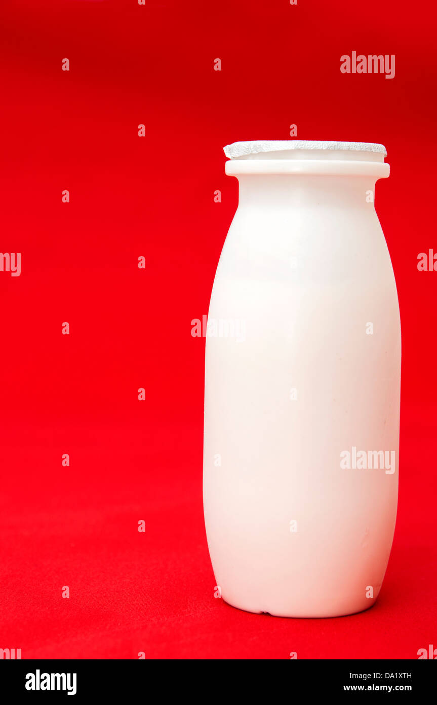 milk cans on a red background Stock Photo - Alamy