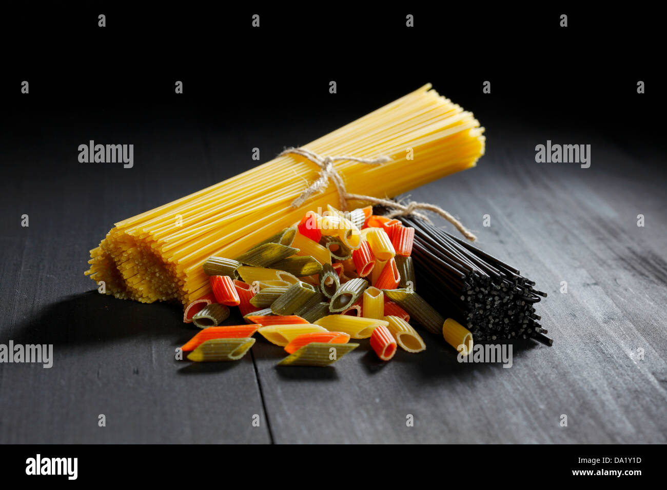 Various Italian pasta on black table Stock Photo - Alamy