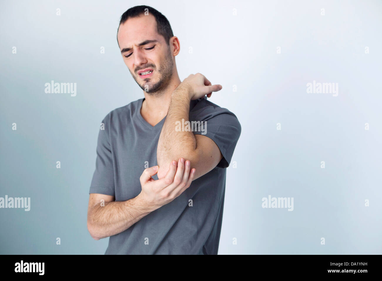 MAN WITH PAINFUL ELBOW Stock Photo - Alamy