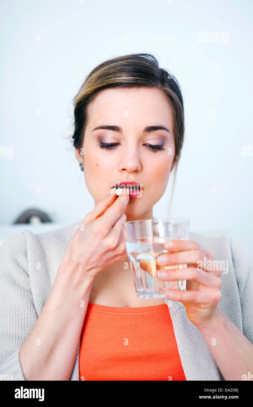 WOMAN TAKING MEDICATION Stock Photo - Alamy