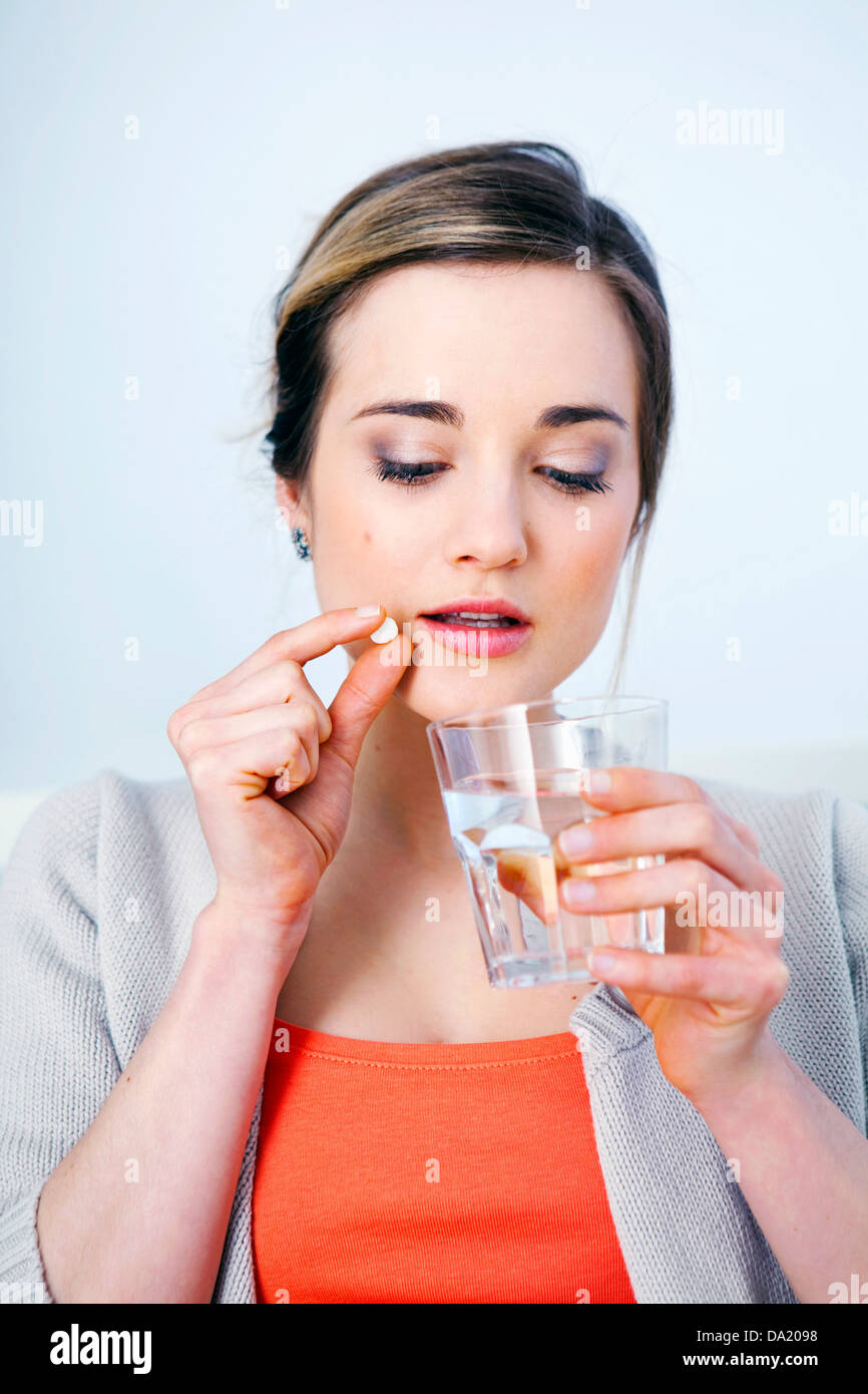 WOMAN TAKING MEDICATION Stock Photo - Alamy