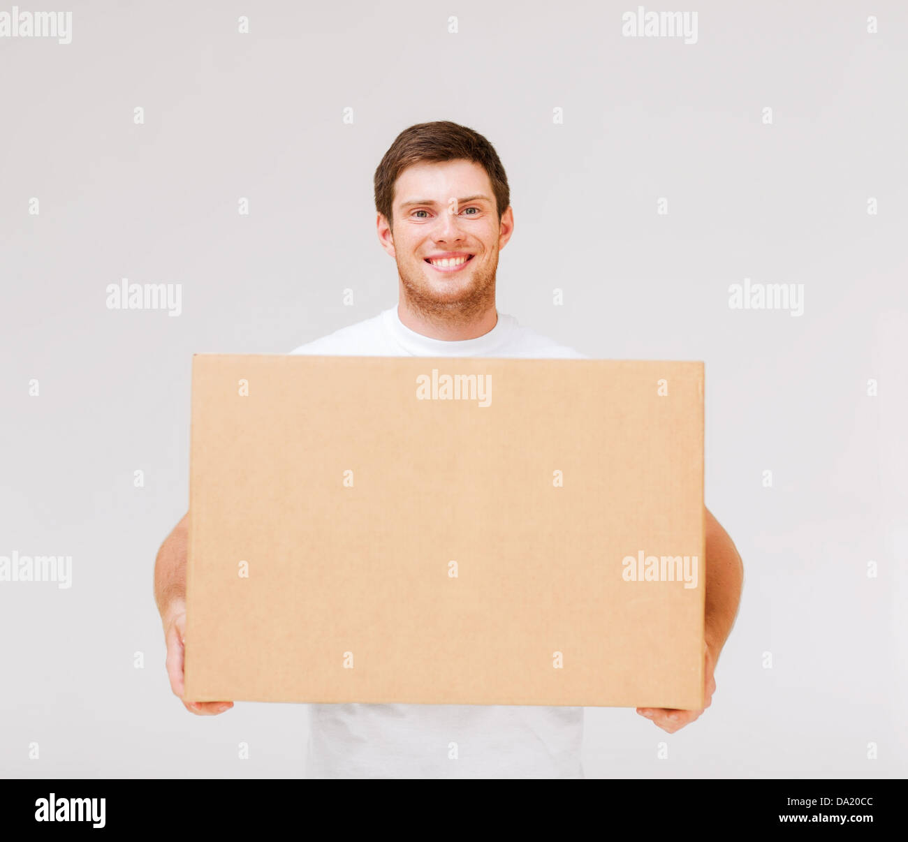 smiling man carrying carton box Stock Photo - Alamy