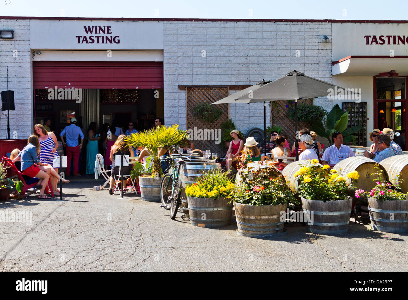 People enjoying wine tasting while sitting out doors in front of a ...