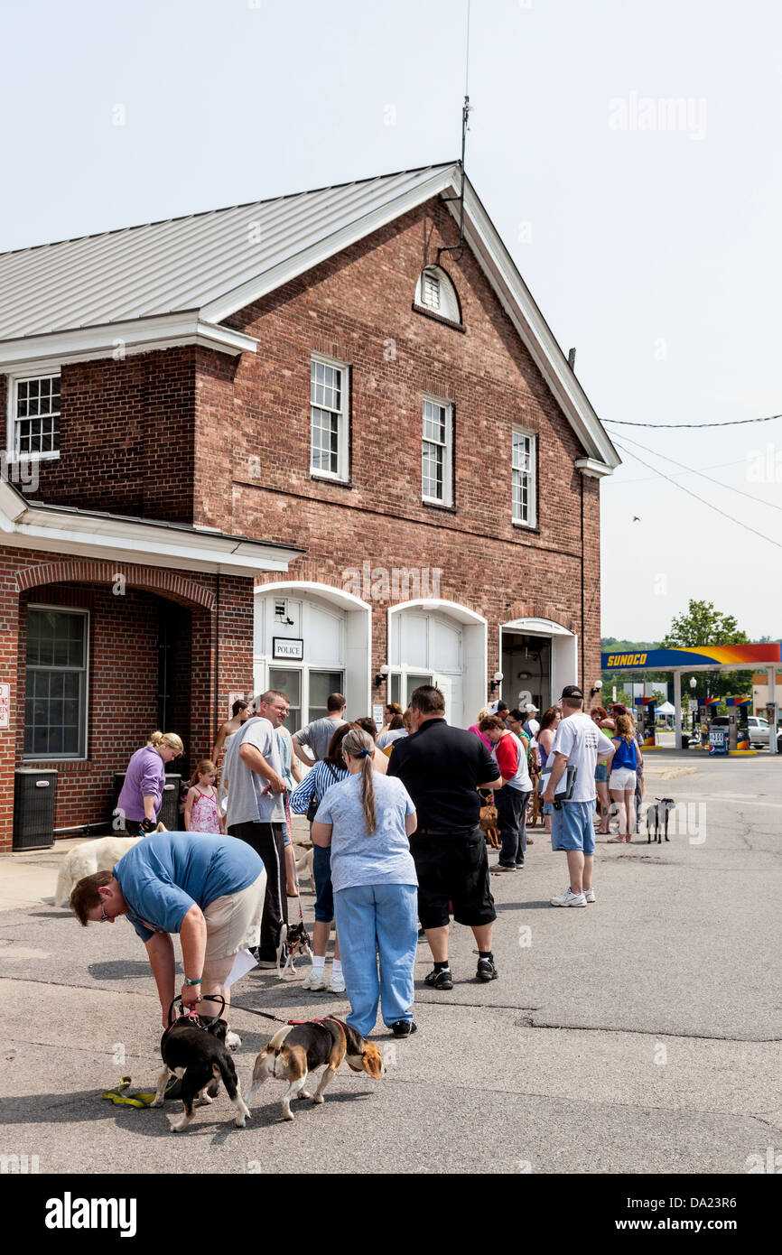 Pet owners queue up with their dogs for free rabies vaccines given by ...