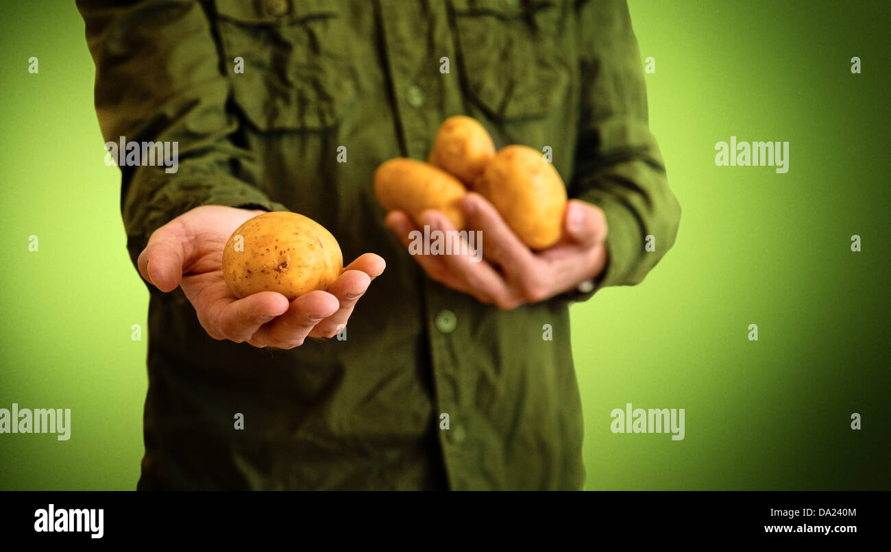 Farmer holding potatoes in hi-res stock photography and images - Alamy