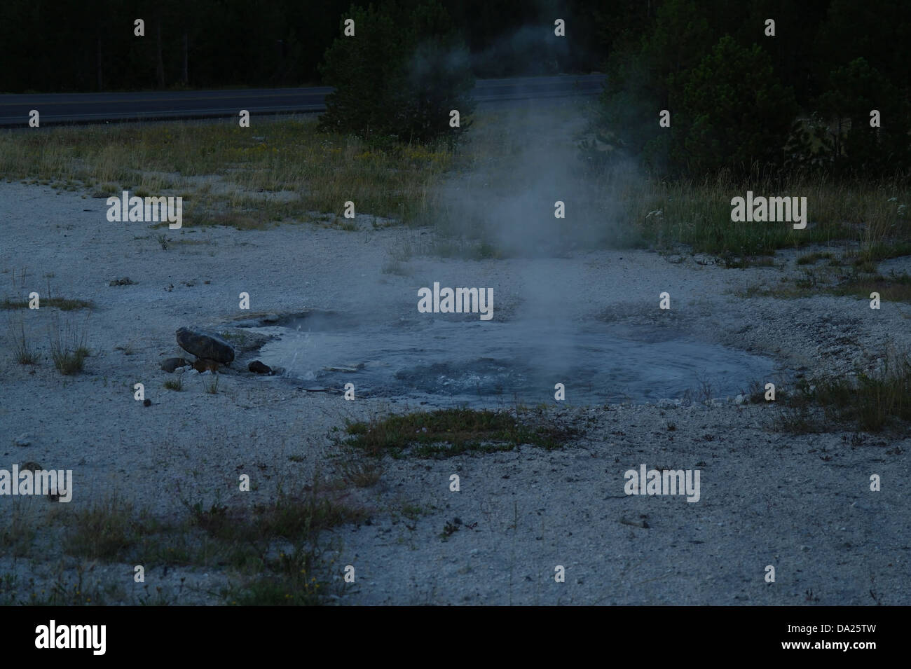 Twilght view steam rising small circular pool in sinter path near Grand ...
