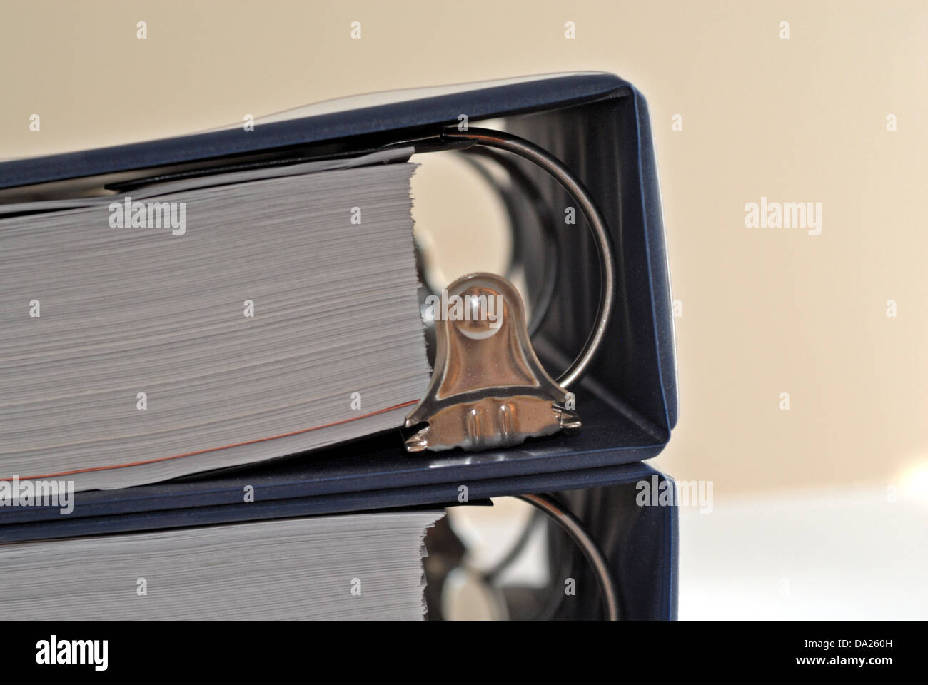Closeup of blue binder full of paper Stock Photo - Alamy