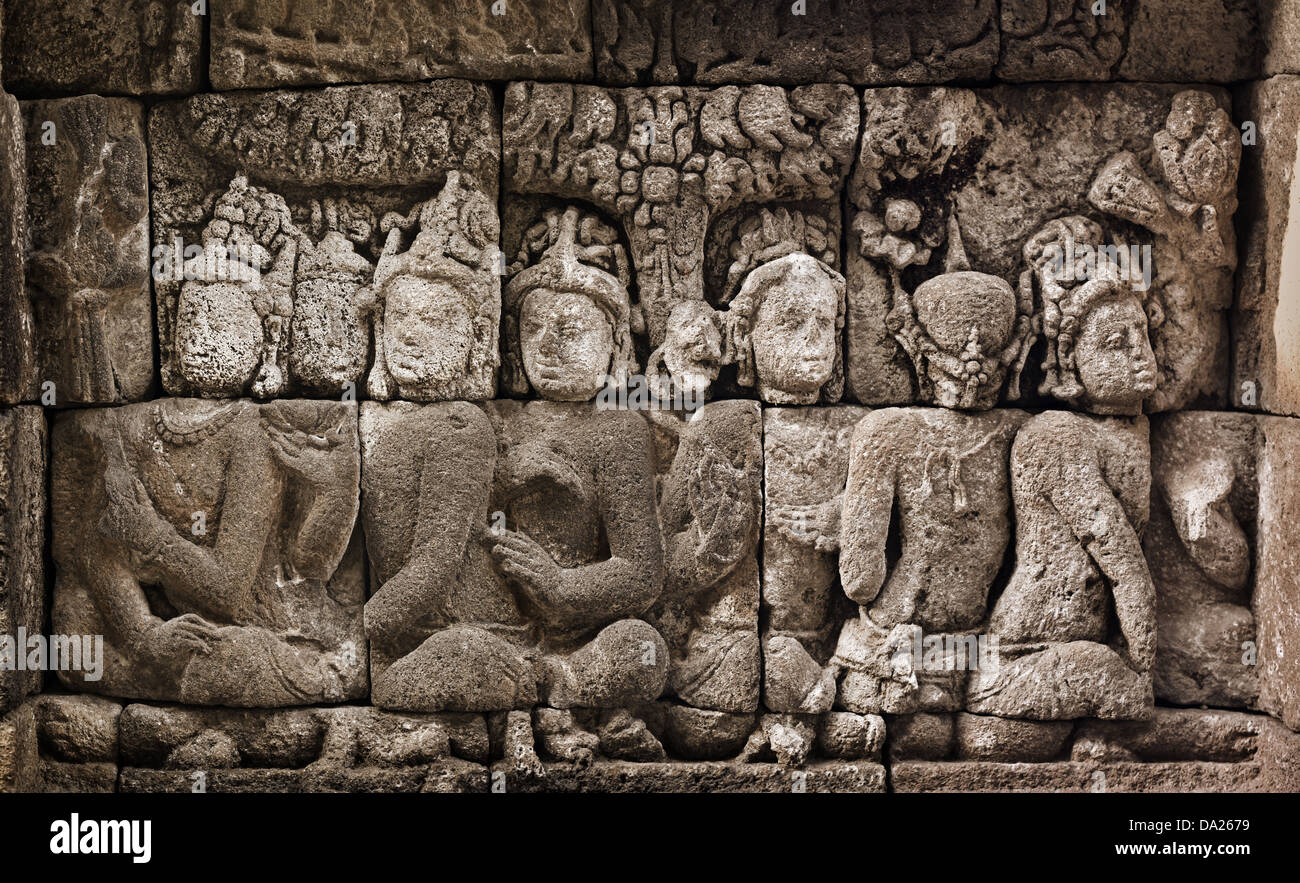 Buddhist carved relief at medieval Borobudur temple on Java, Indonesia ...