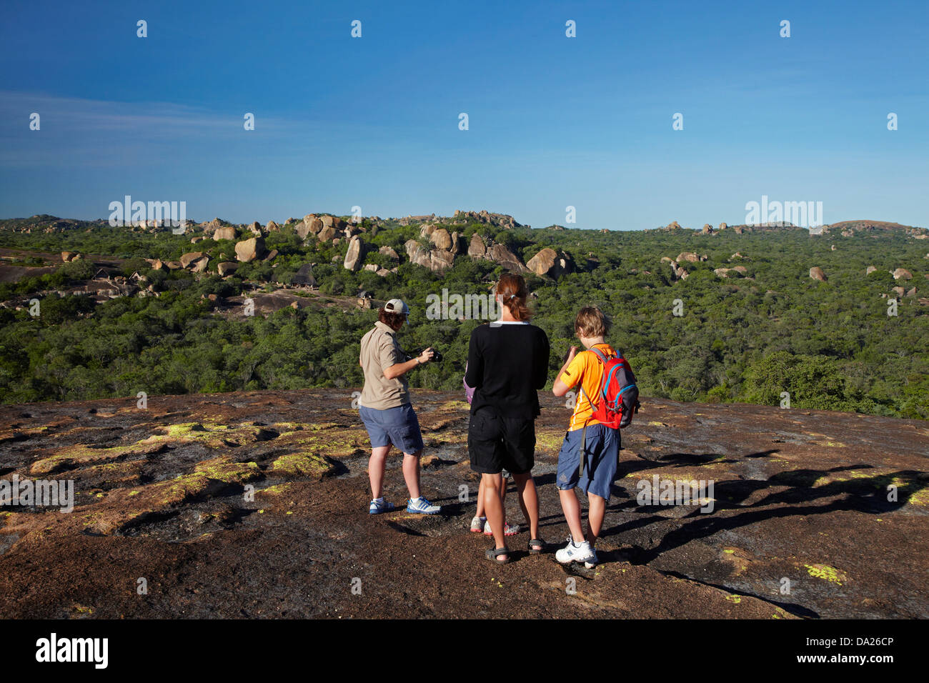 Tourists hiking above Big Cave Camp (in distance) blending in to the ...