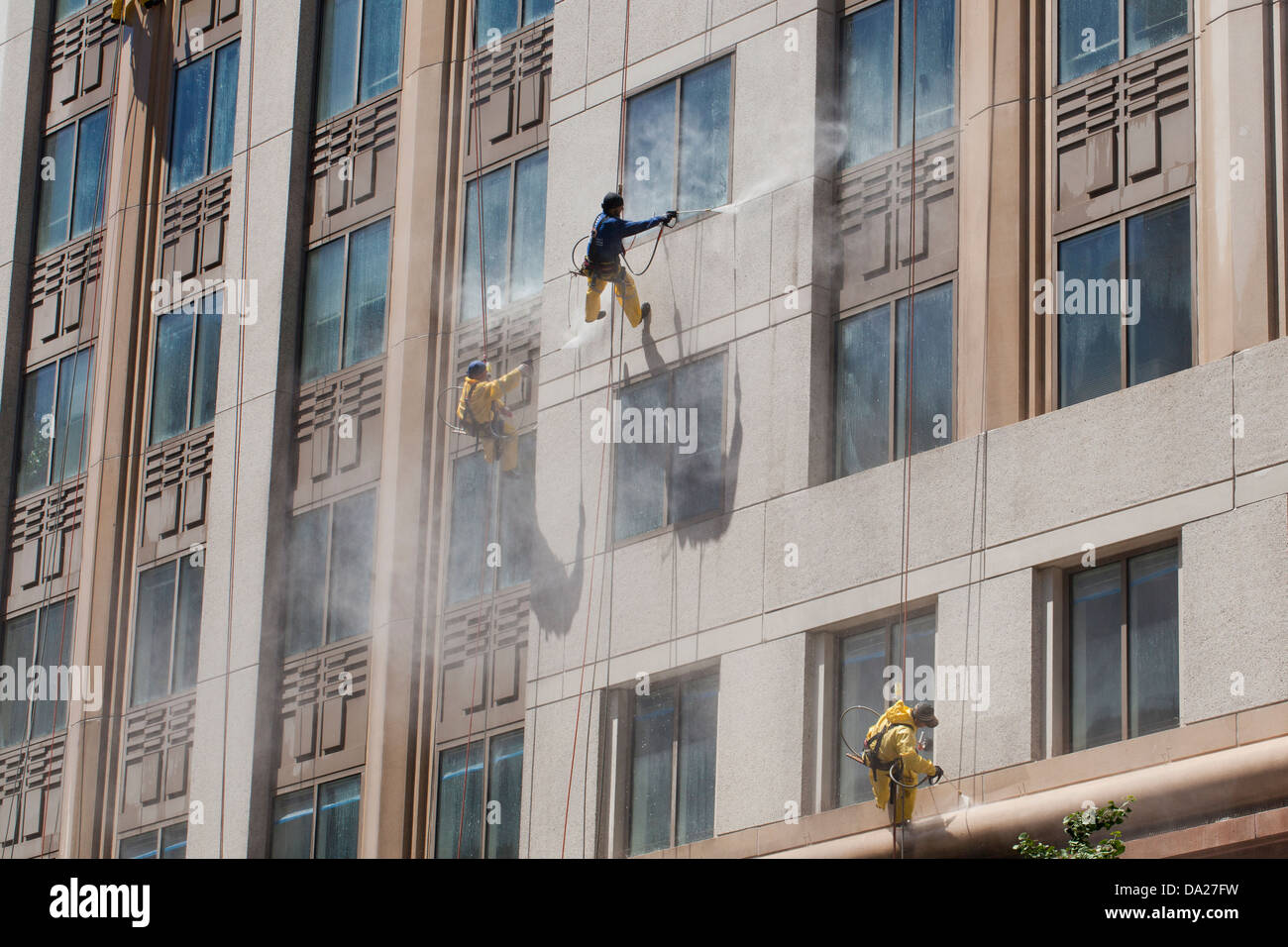 High rise building maintenance crew cleaning with pressure washer Stock ...