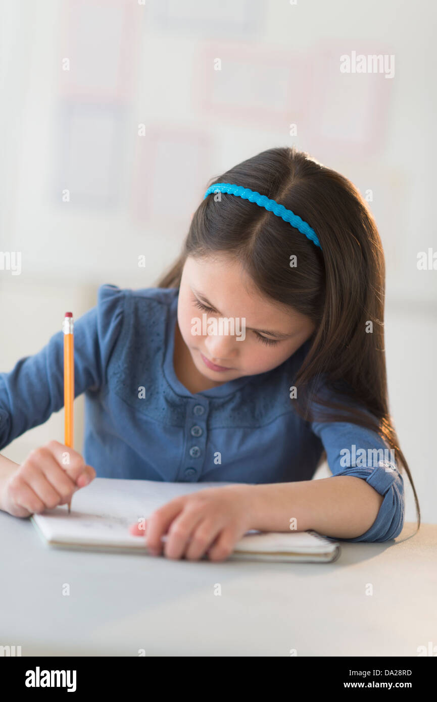 Schoolgirl writing classroom desk hi-res stock photography and images ...