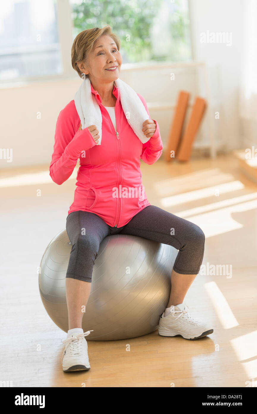 Senior woman exercising with fitness ball Stock Photo - Alamy