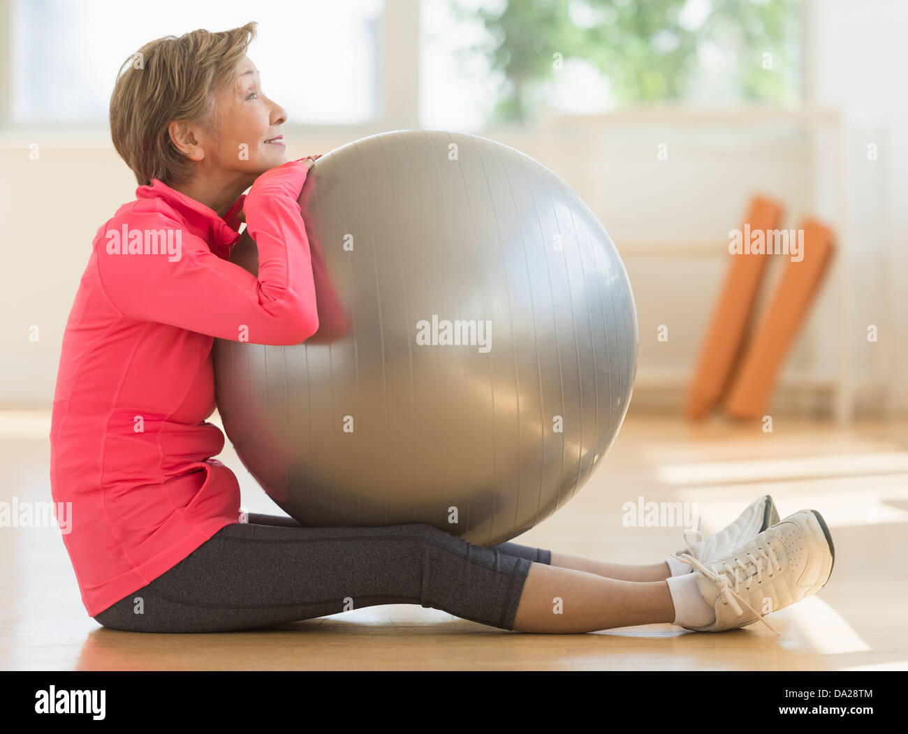 Senior woman exercising with fitness ball Stock Photo - Alamy