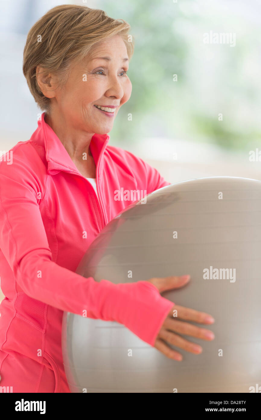 Senior woman exercising with fitness ball Stock Photo - Alamy