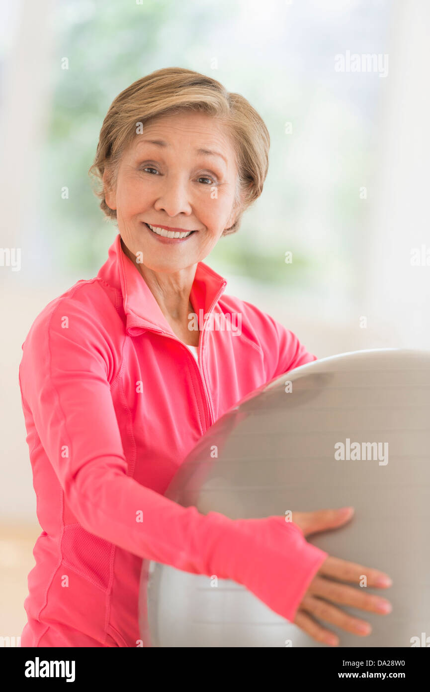 Senior woman exercising with fitness ball Stock Photo - Alamy