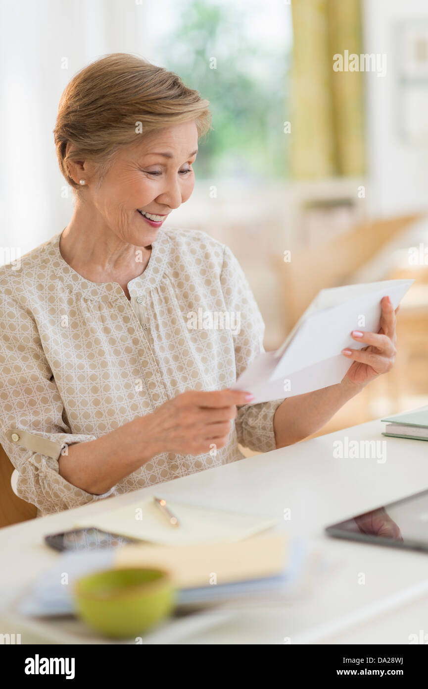 Senior woman reading letter Stock Photo - Alamy
