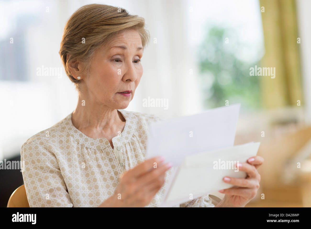 Senior woman reading letter Stock Photo - Alamy