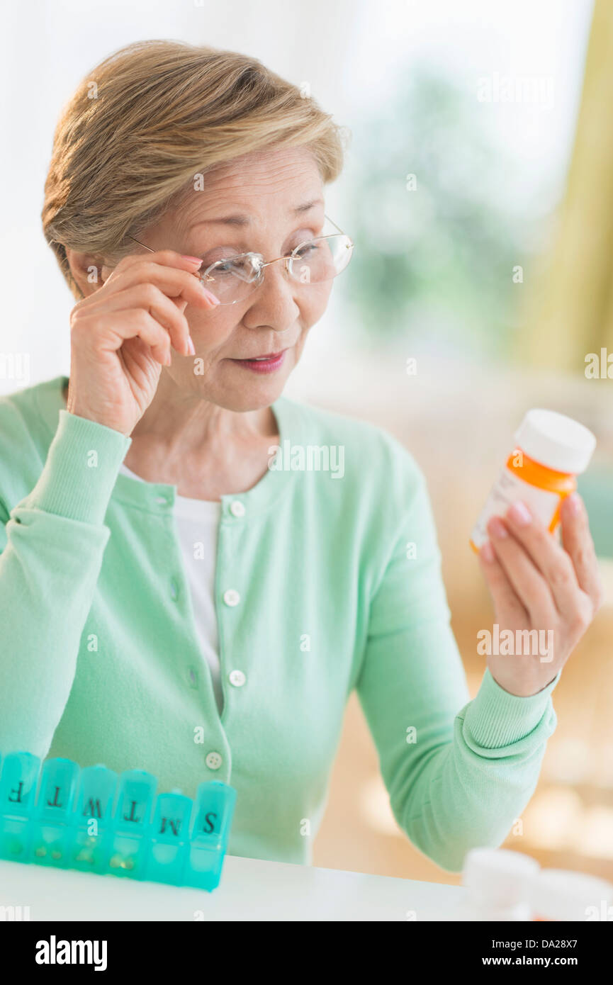 Senior woman medicine container hi-res stock photography and images - Alamy
