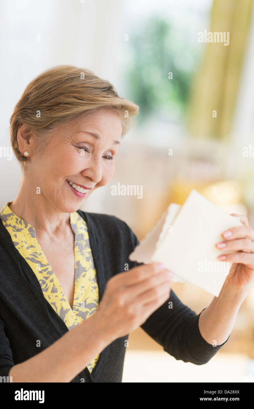 Senior woman reading note Stock Photo - Alamy
