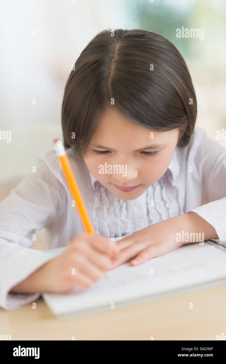 Girl (8-9) doing homework Stock Photo - Alamy