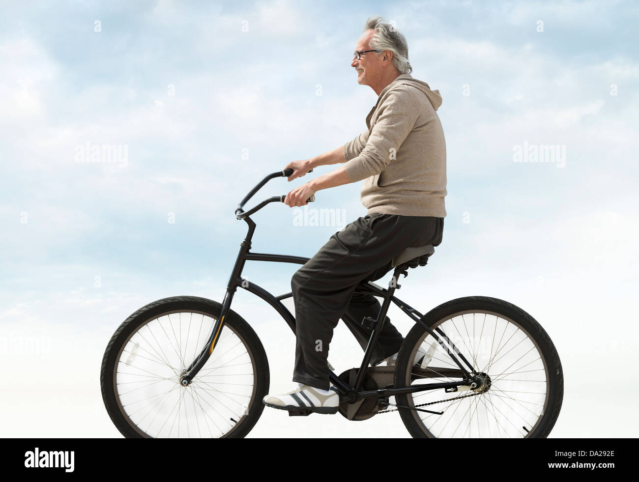 Senior man riding bicycle Stock Photo - Alamy