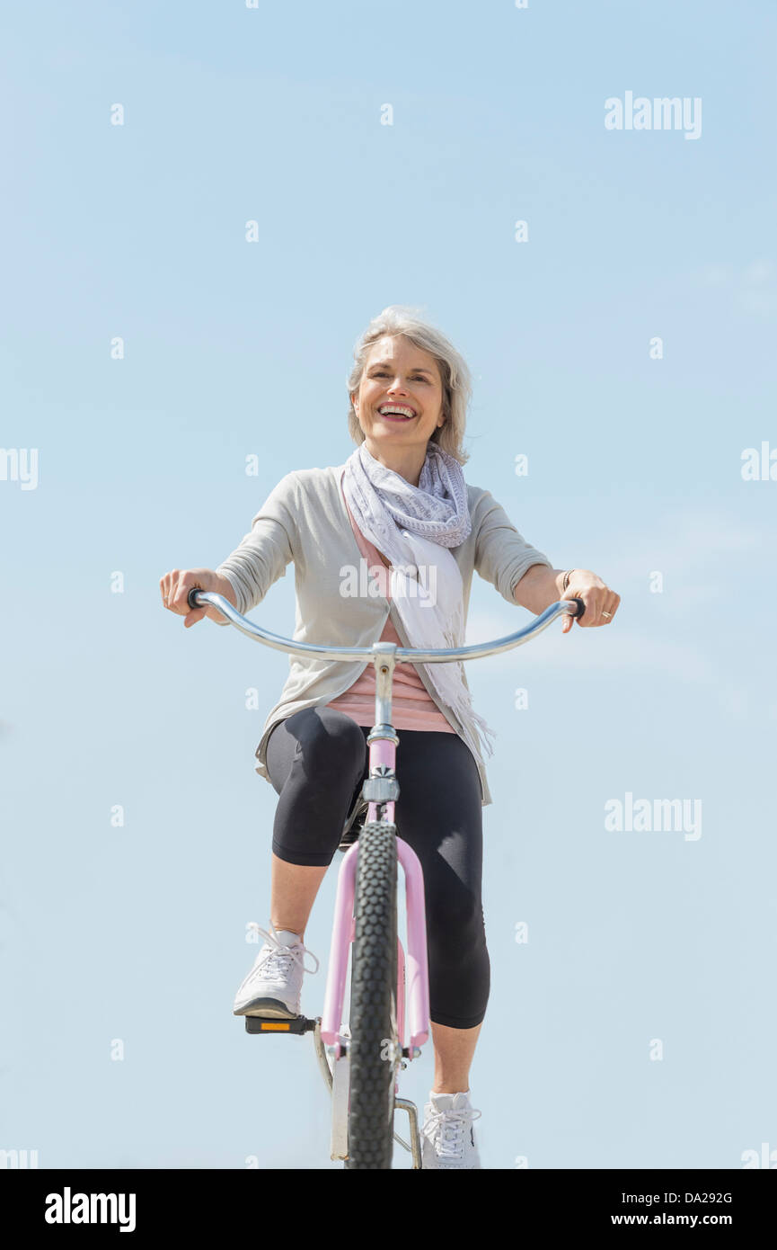 Senior woman riding bicycle Stock Photo - Alamy