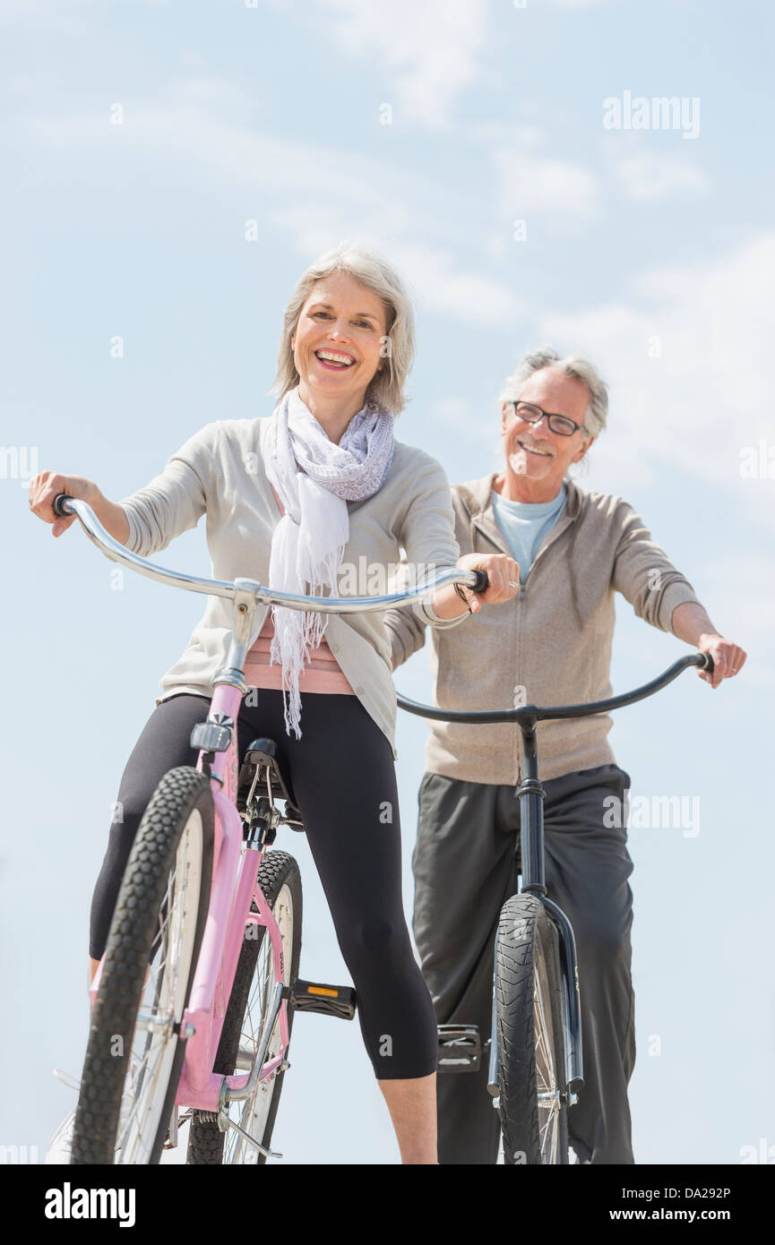 Senior couple riding bicycle Stock Photo - Alamy