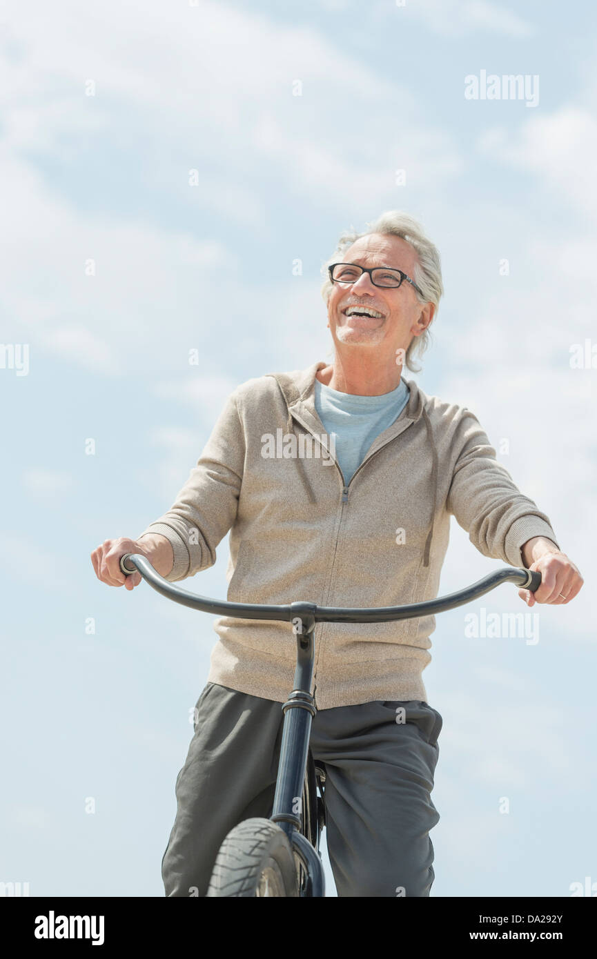 Senior man riding bicycle Stock Photo - Alamy