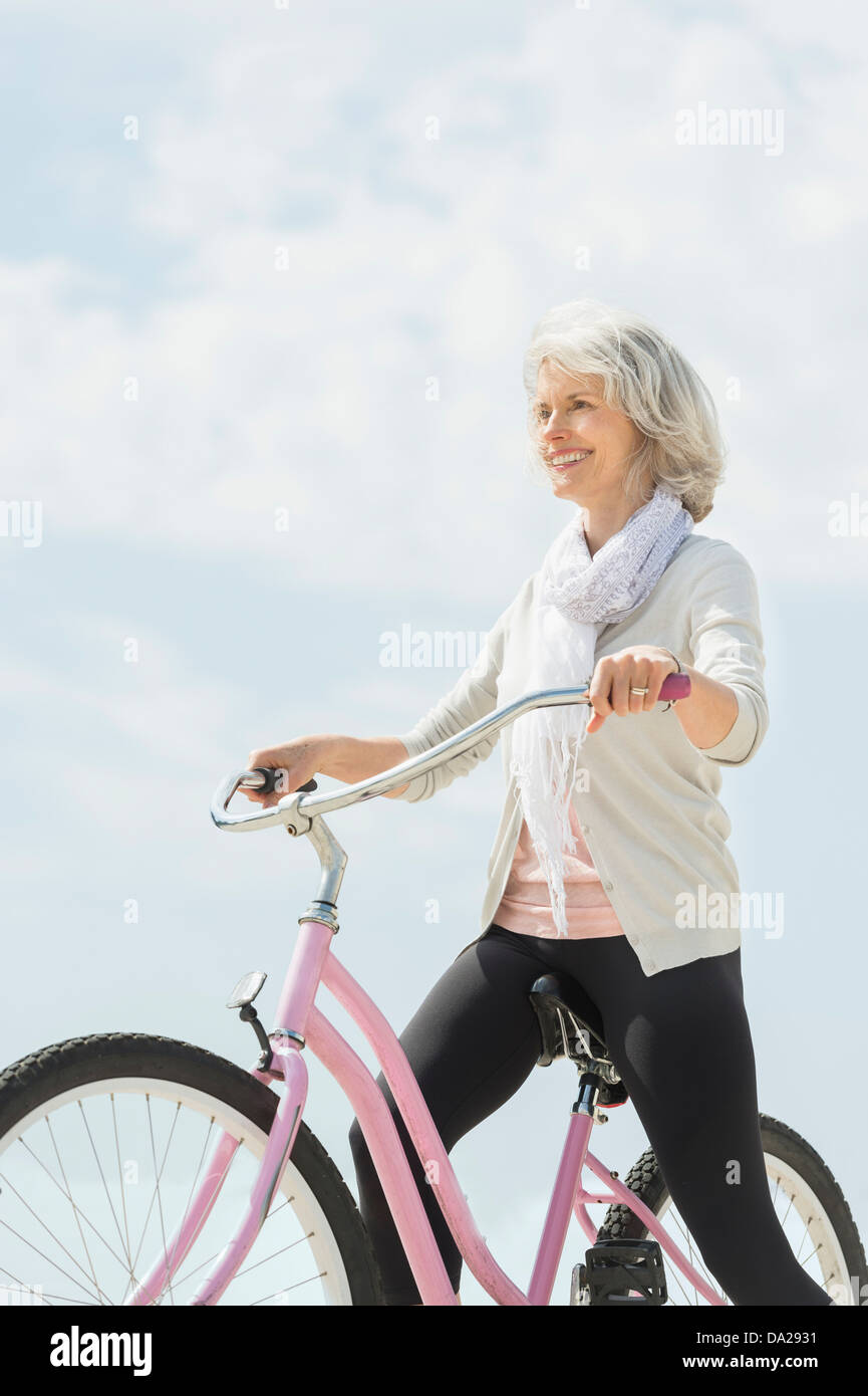 Senior woman riding bicycle Stock Photo - Alamy