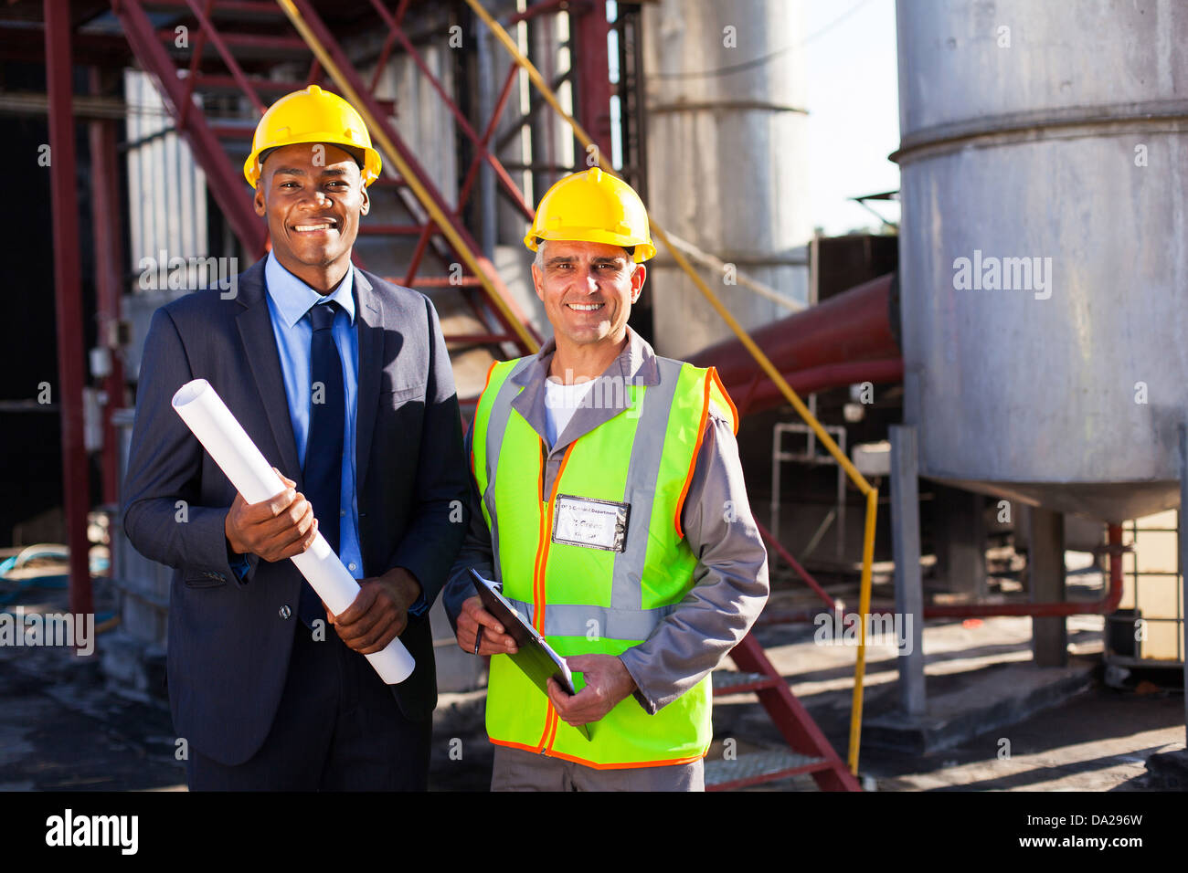 cheerful chemical industry manager and workers at factory Stock Photo ...