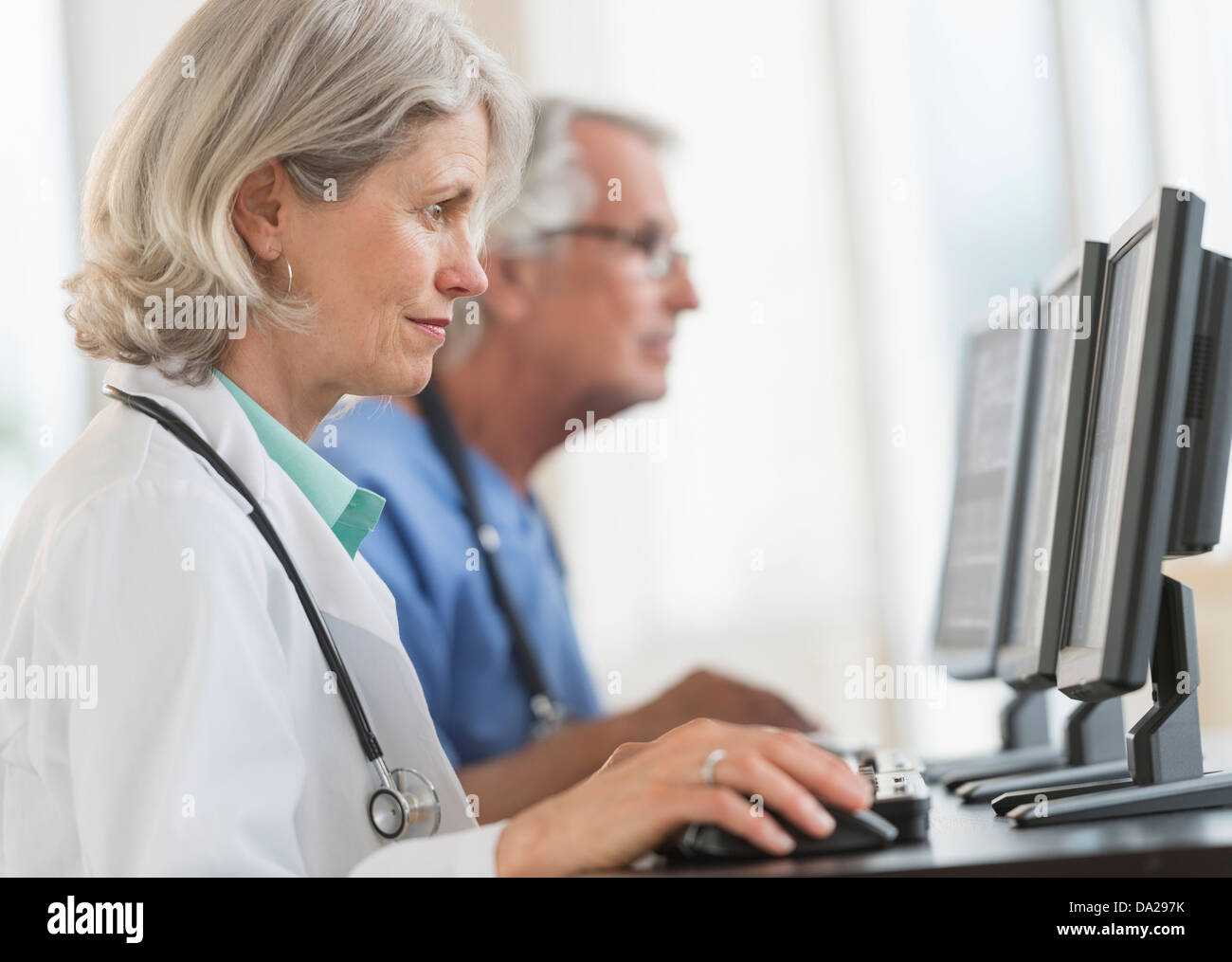 Female and male doctors working at computers Stock Photo - Alamy