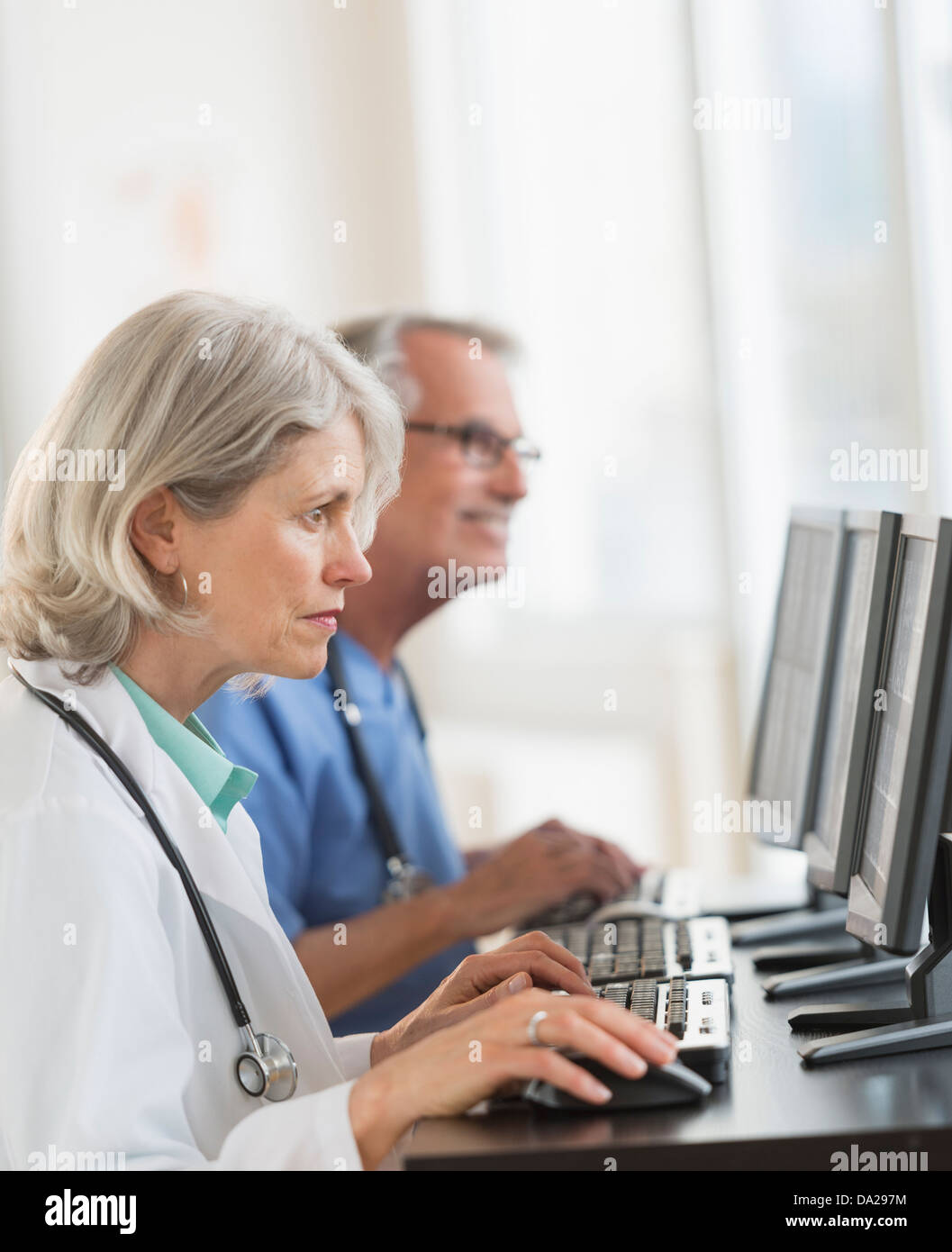 Female and male doctors working at computers Stock Photo - Alamy