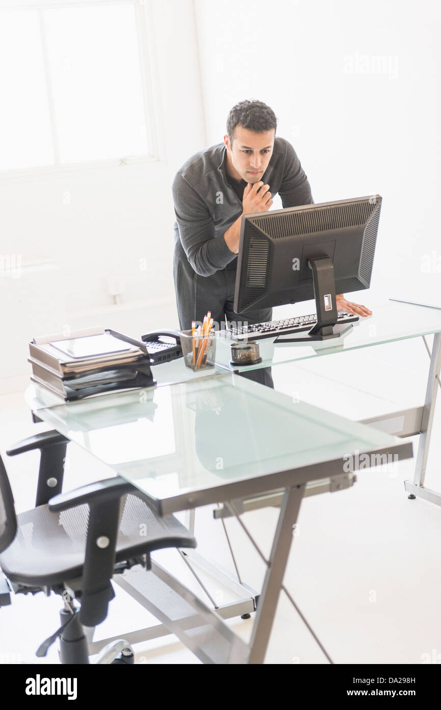 Businessman working at desk Stock Photo - Alamy
