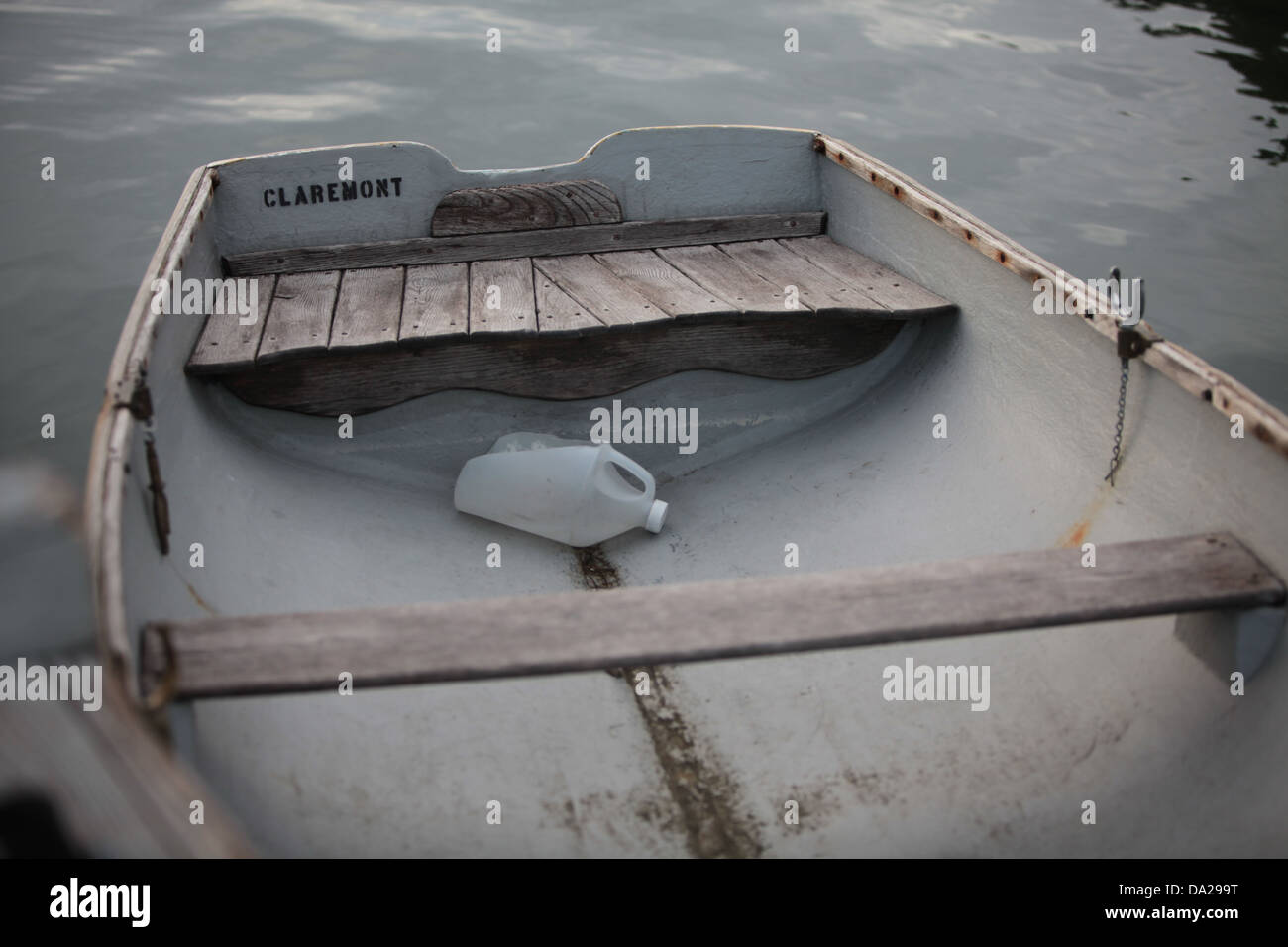 Empty row boat marked Claremont on calm waters near Acadia National ...