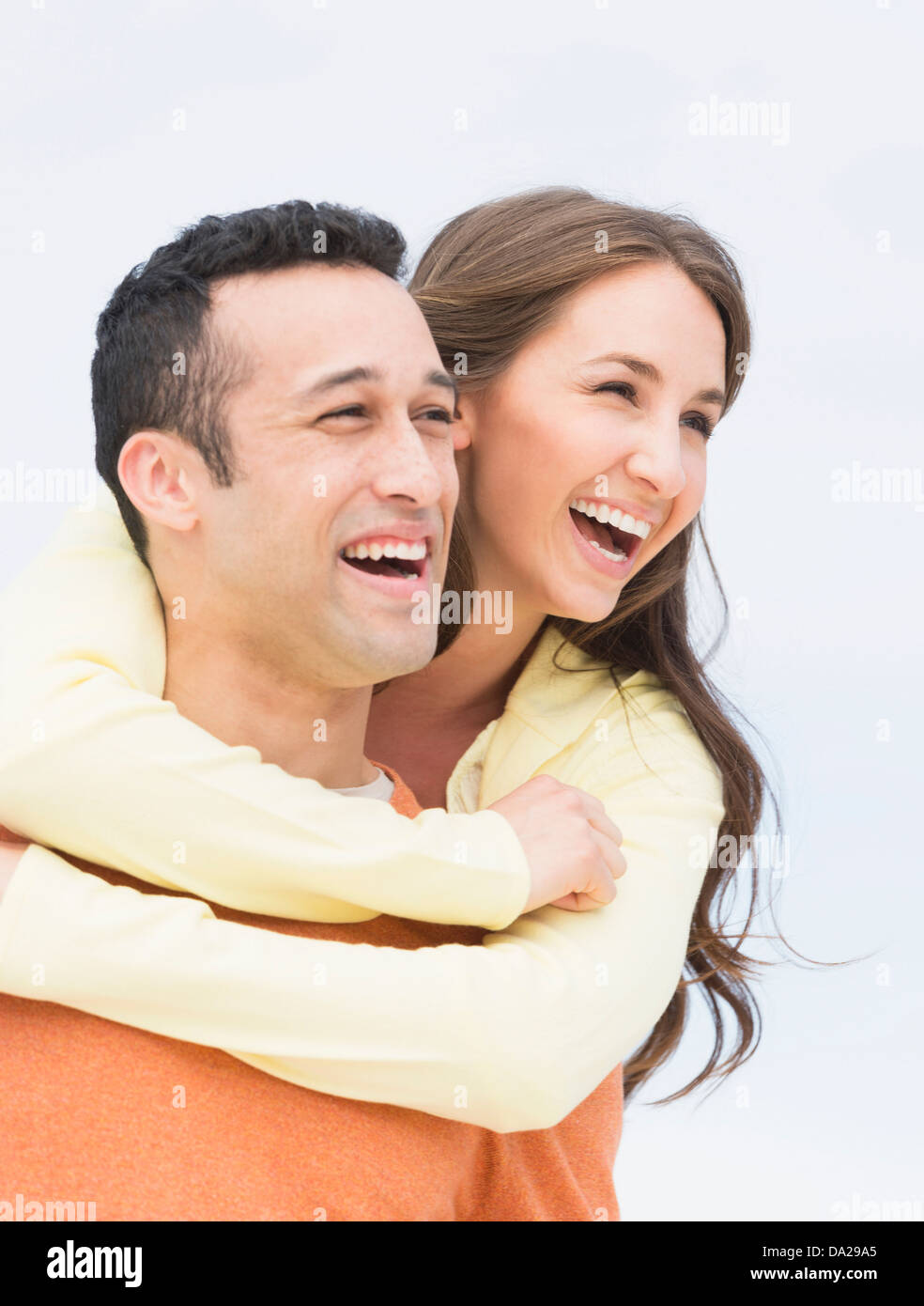 Happy young couple embracing Stock Photo - Alamy