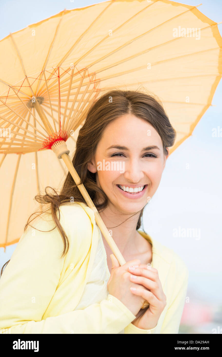 Portrait of beautiful young woman with parasol Stock Photo - Alamy