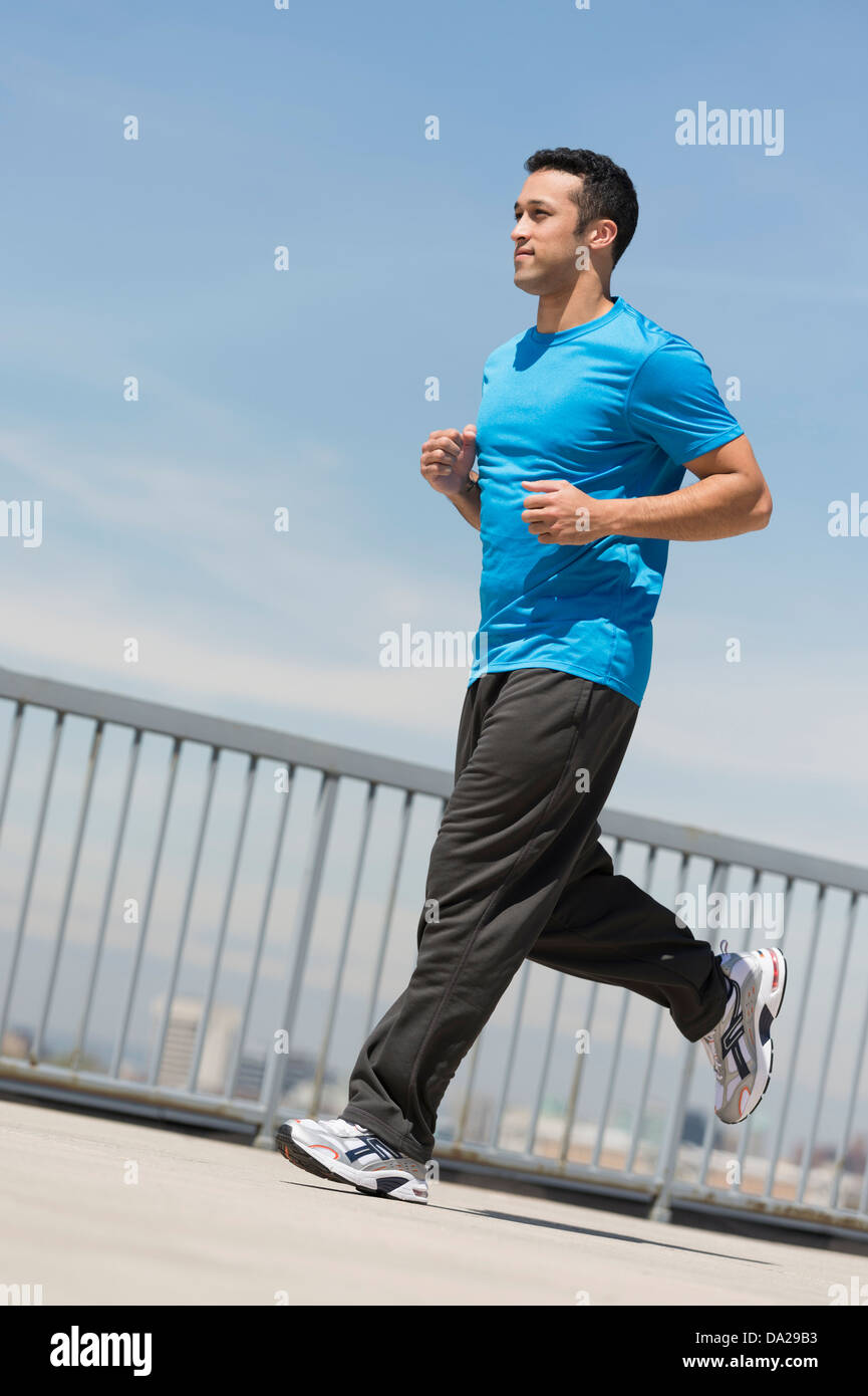 Young man running Stock Photo - Alamy