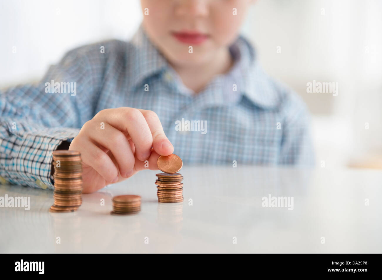 Boy counting coins hi-res stock photography and images - Alamy