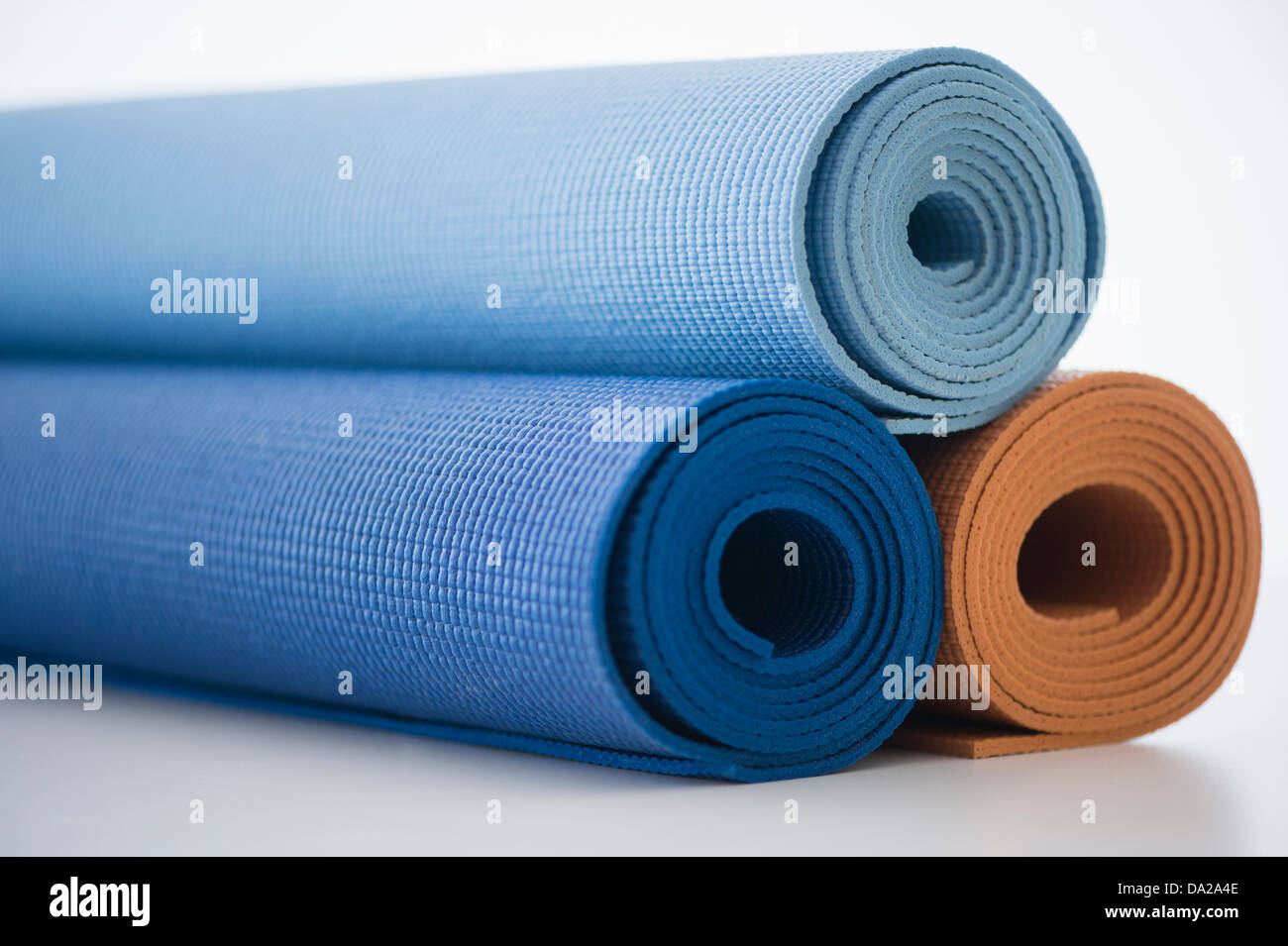 Studio Shot of rolled up exercise mats Stock Photo - Alamy