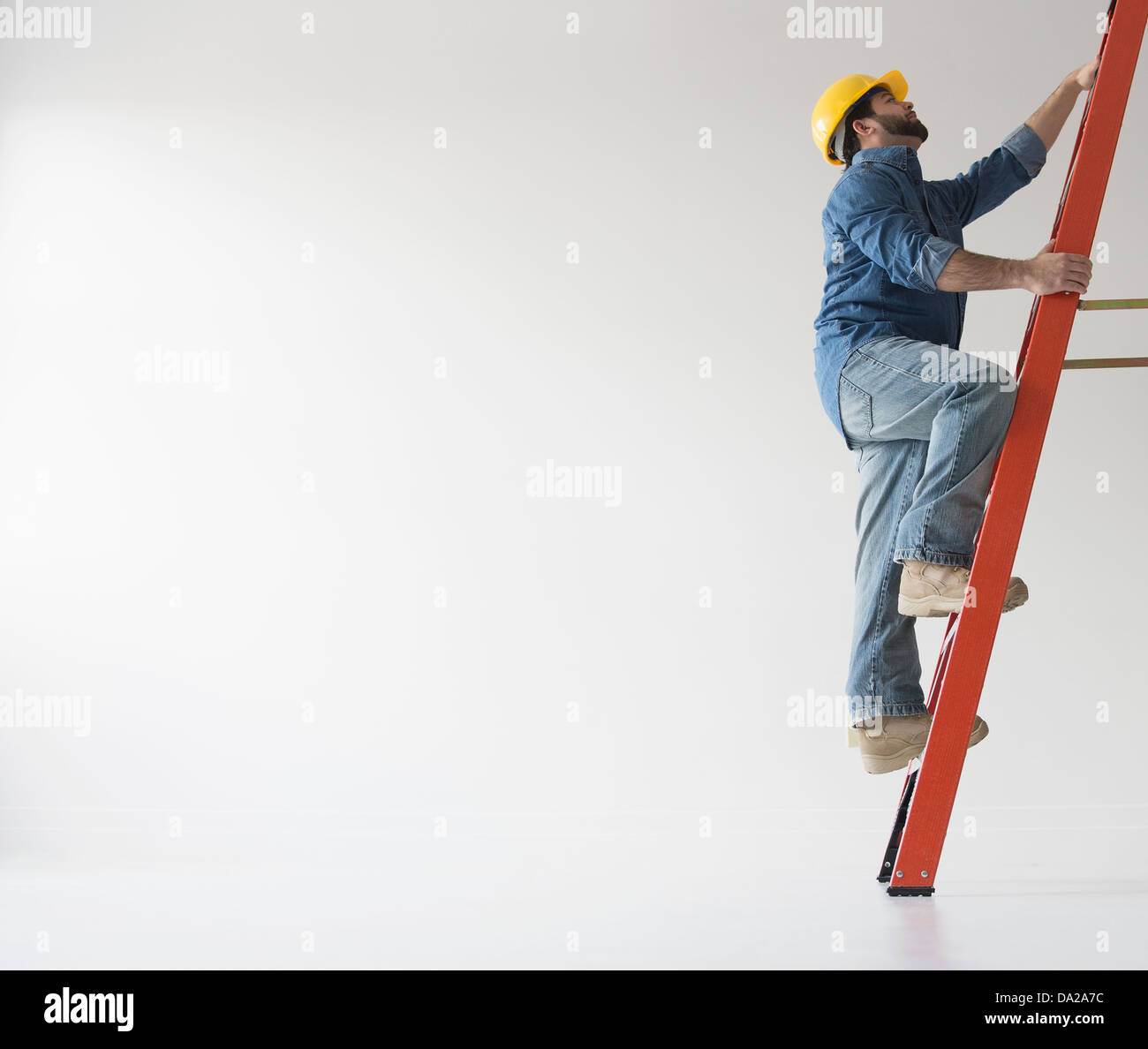 Man climbing up ladder Stock Photo - Alamy