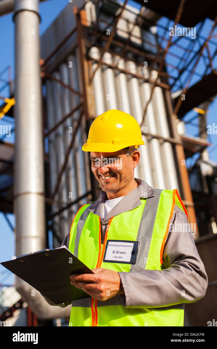 happy middle aged heavy industry worker working in plant Stock Photo ...