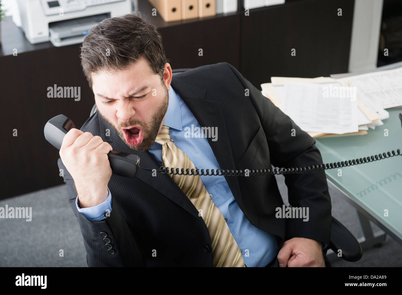 Portrait of man shouting on phone Stock Photo - Alamy