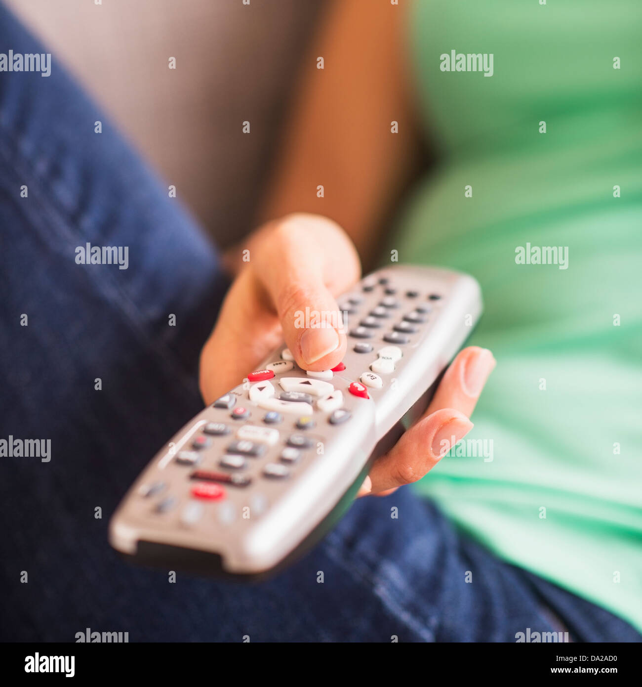 Close up of woman's hand holding remote control Stock Photo - Alamy