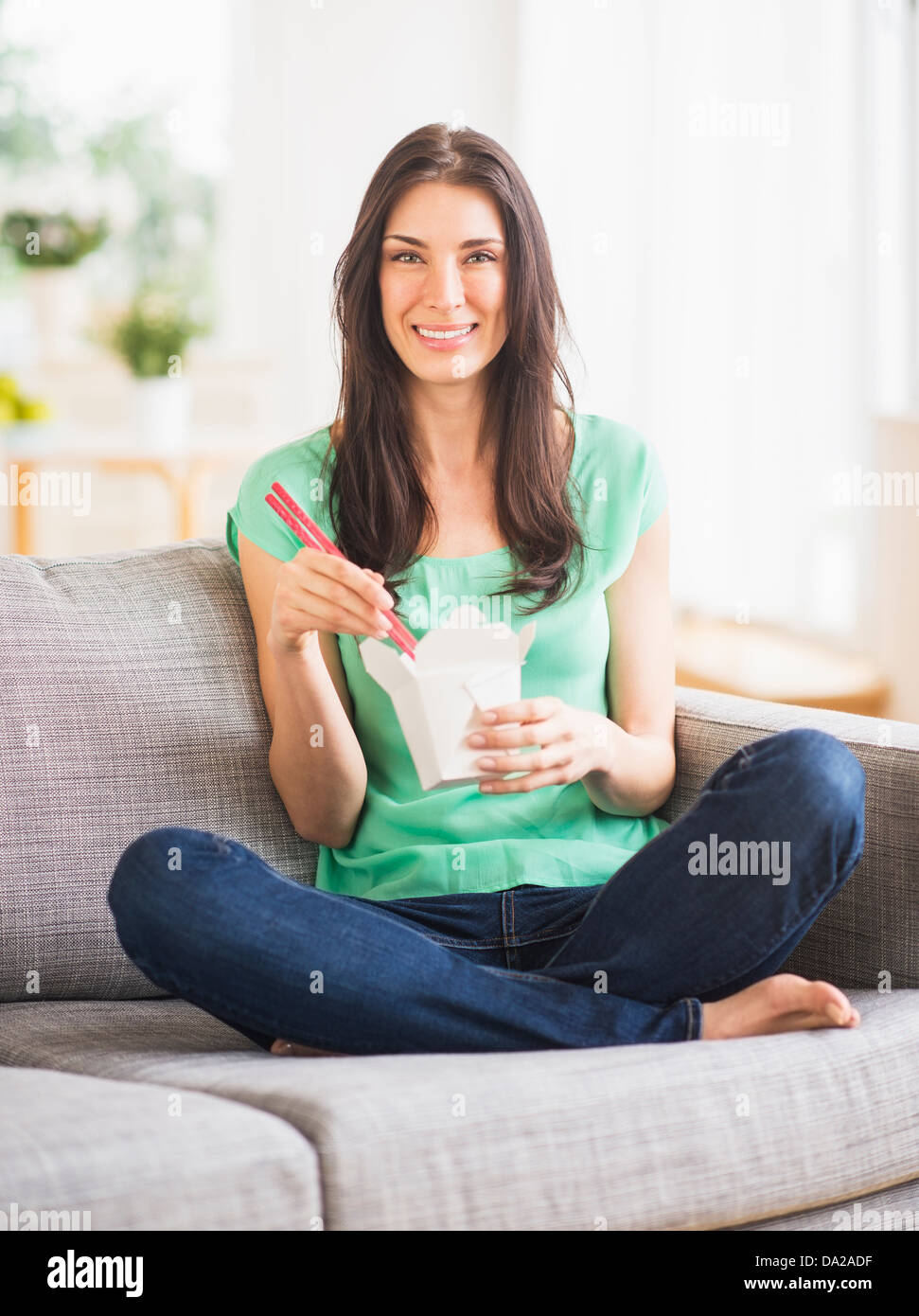 Portrait of woman eating take out food Stock Photo - Alamy