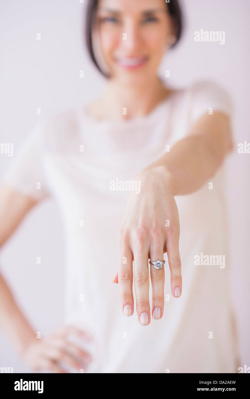Studio Shot of woman showing her engagement ring Stock Photo - Alamy