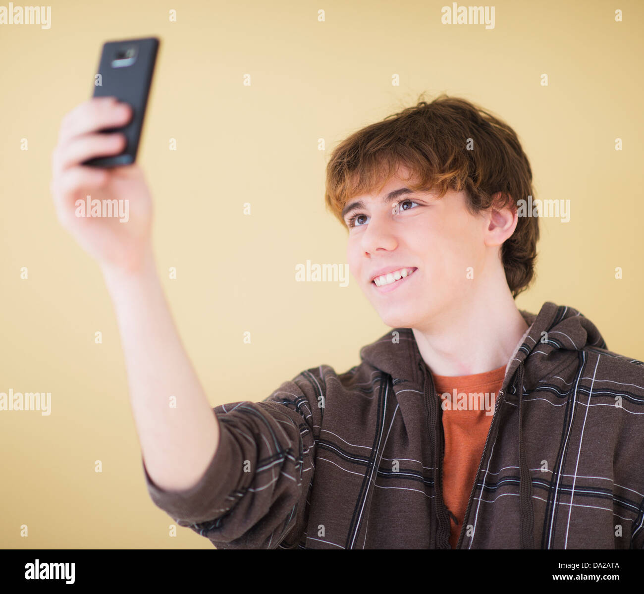 Teenage boy (14-15) photographing himself with mobile phone Stock Photo ...