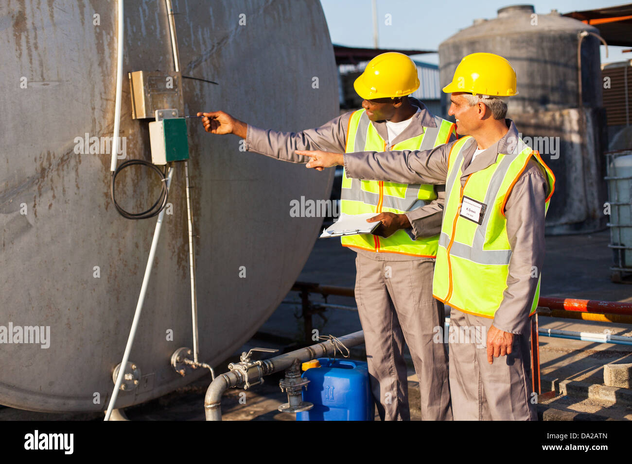 two industrial engineers inspection fuel tank in chemical plant Stock ...