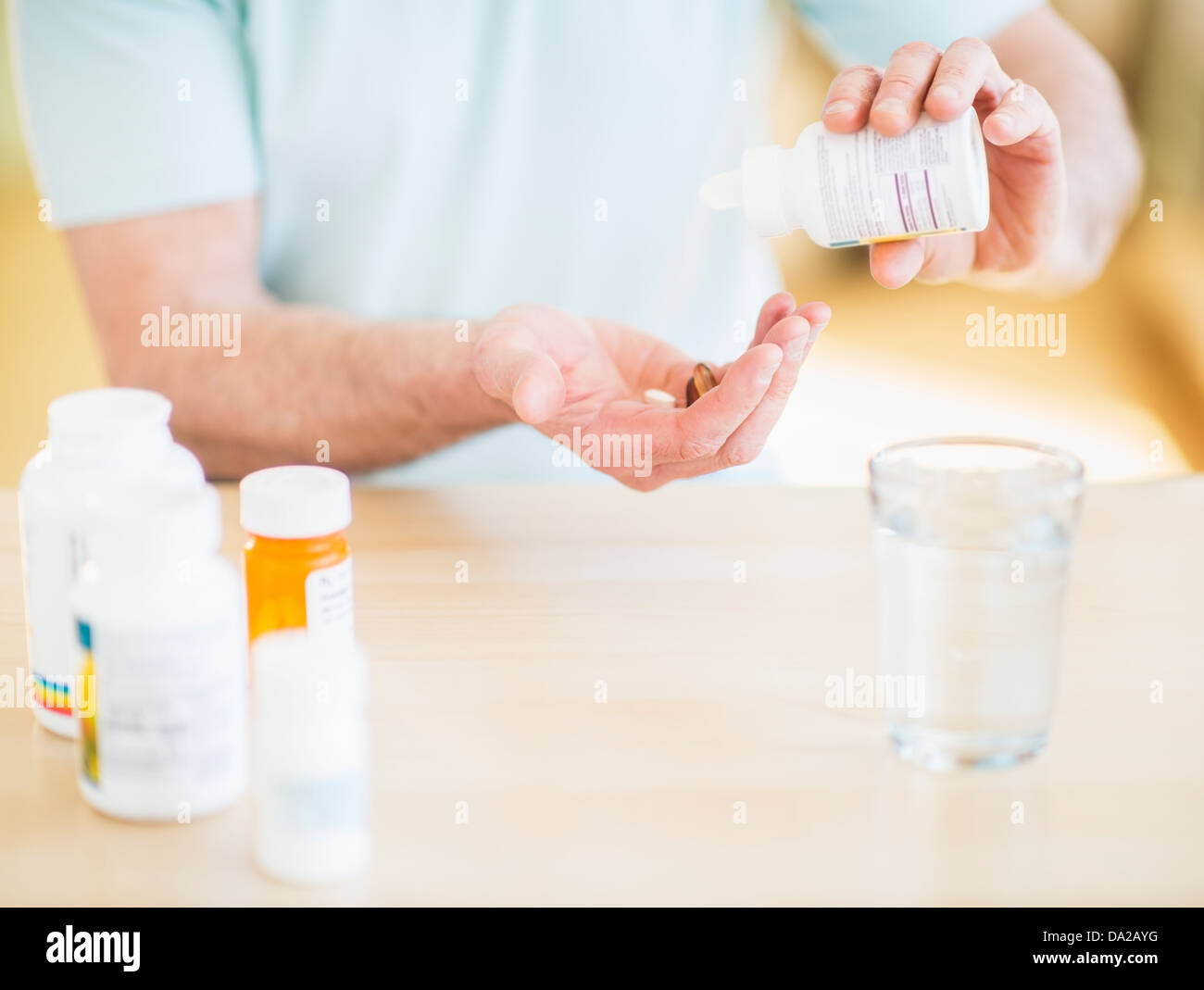 Mid section of man taking medicine Stock Photo - Alamy