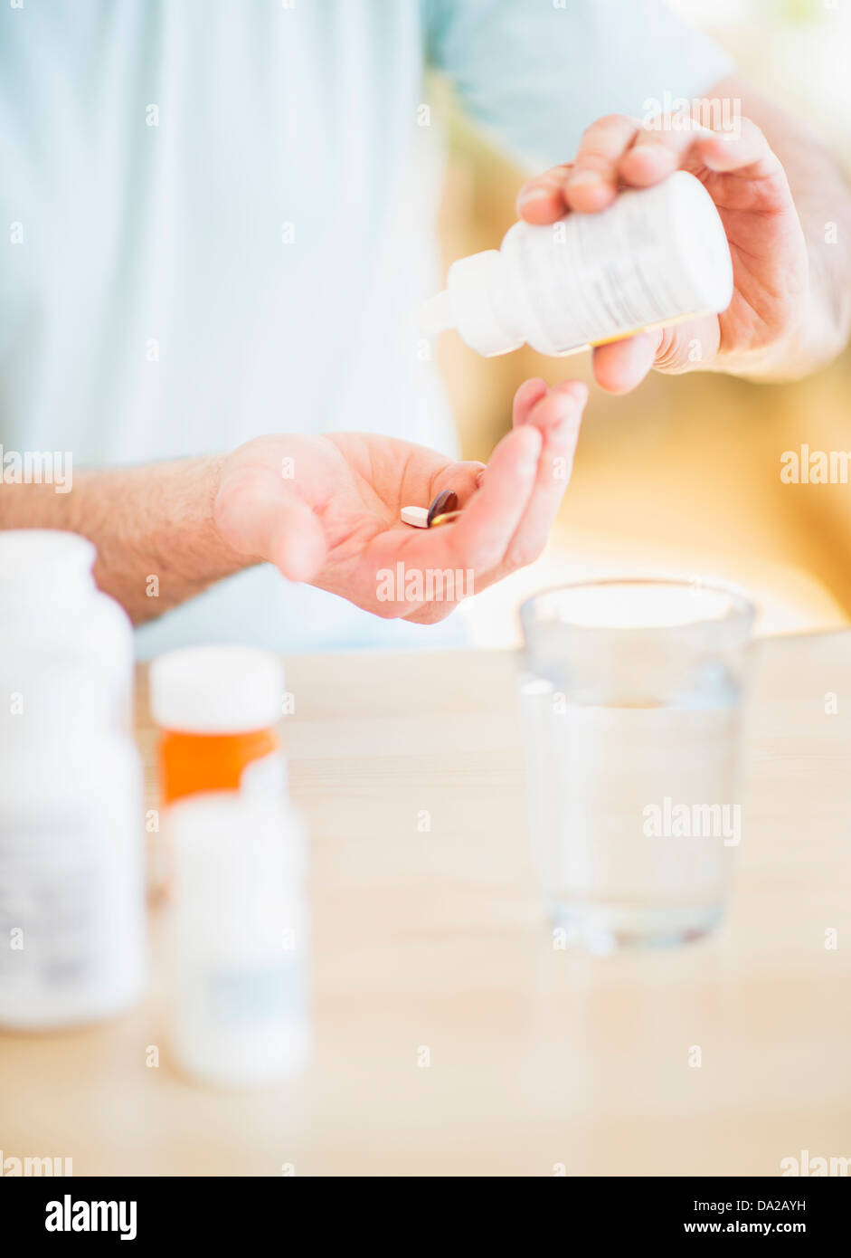 Mid section of man taking medicine Stock Photo - Alamy
