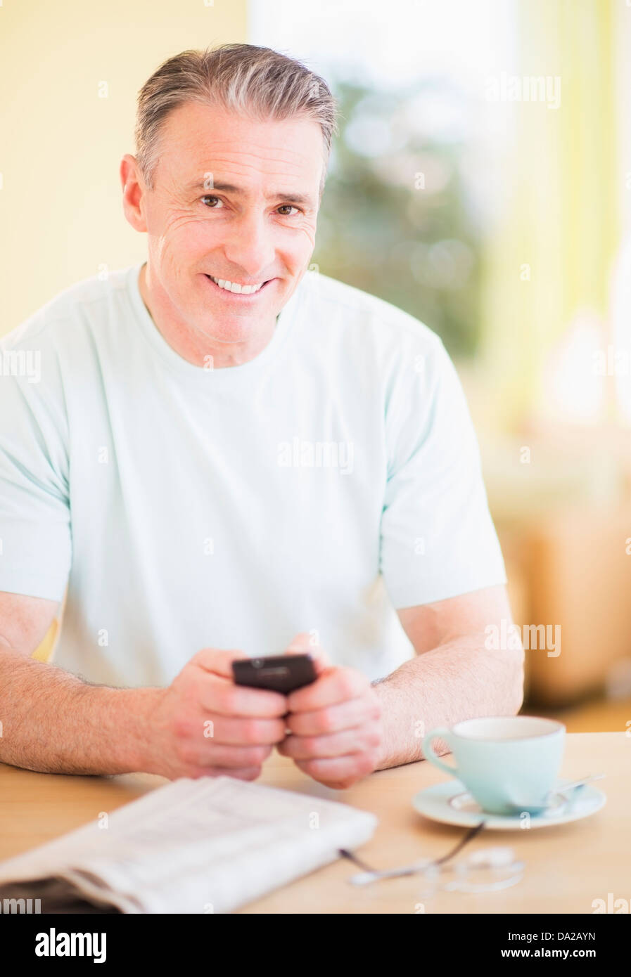 Portrait of man at kitchen table Stock Photo - Alamy